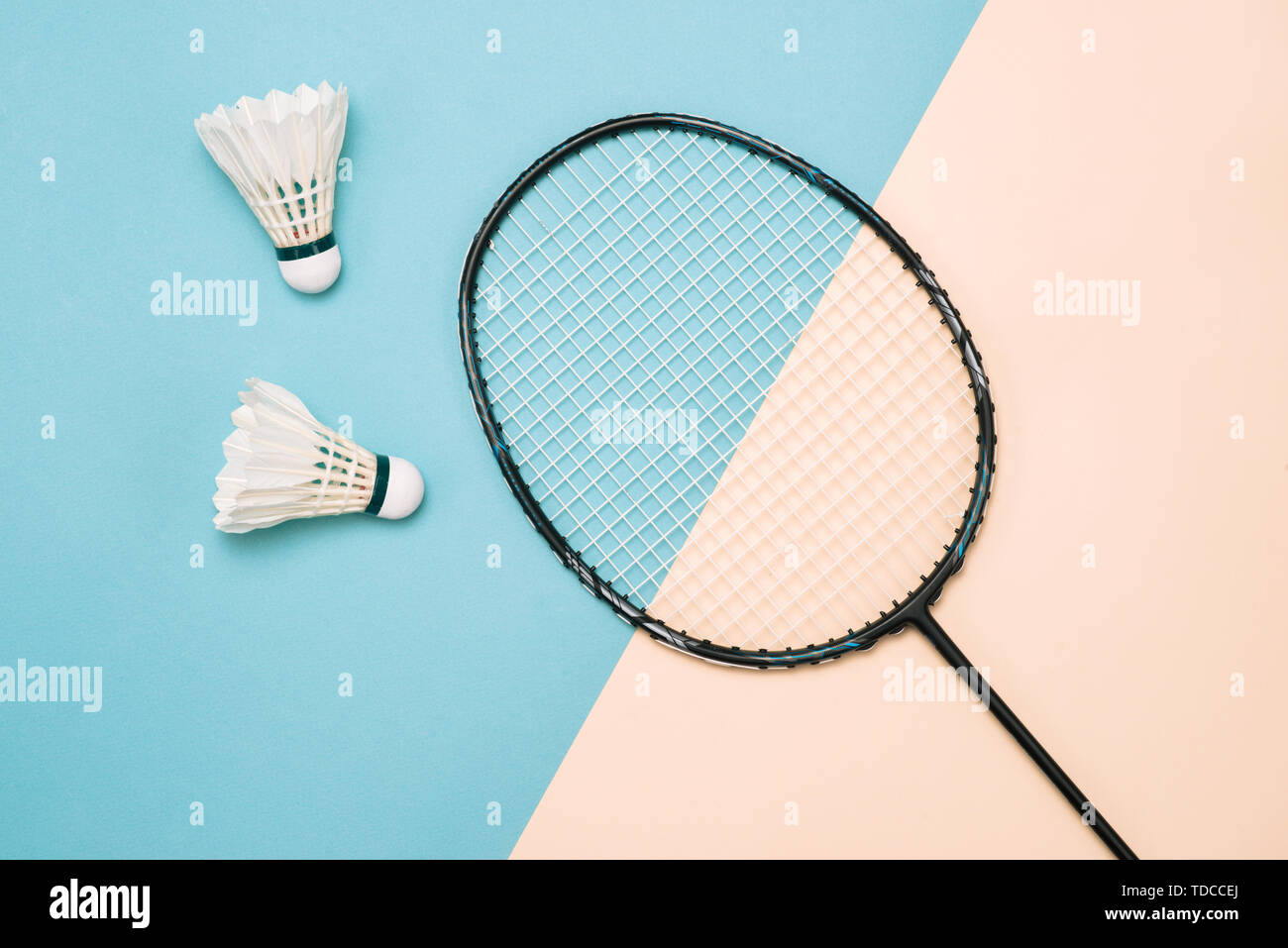 Shuttlecock and racket for playing badminton on a pástel color ...