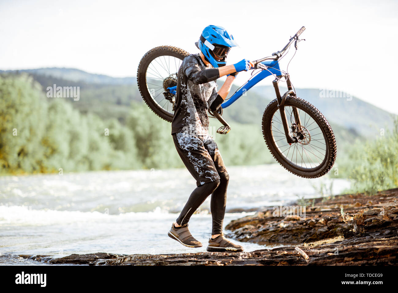 Man carrying mountain bike in river hi-res stock photography and images ...