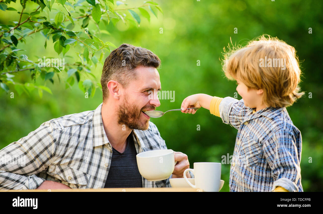 healthy food. Family day bonding. father and son eat outdoor. small boy ...