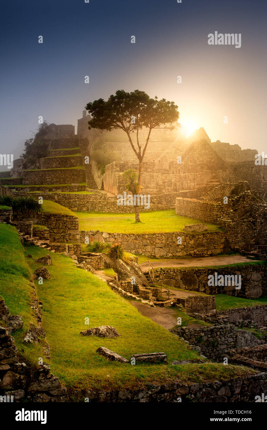 Epic sunrise over the Machu Picchu city ruins covered with fog and sun ...