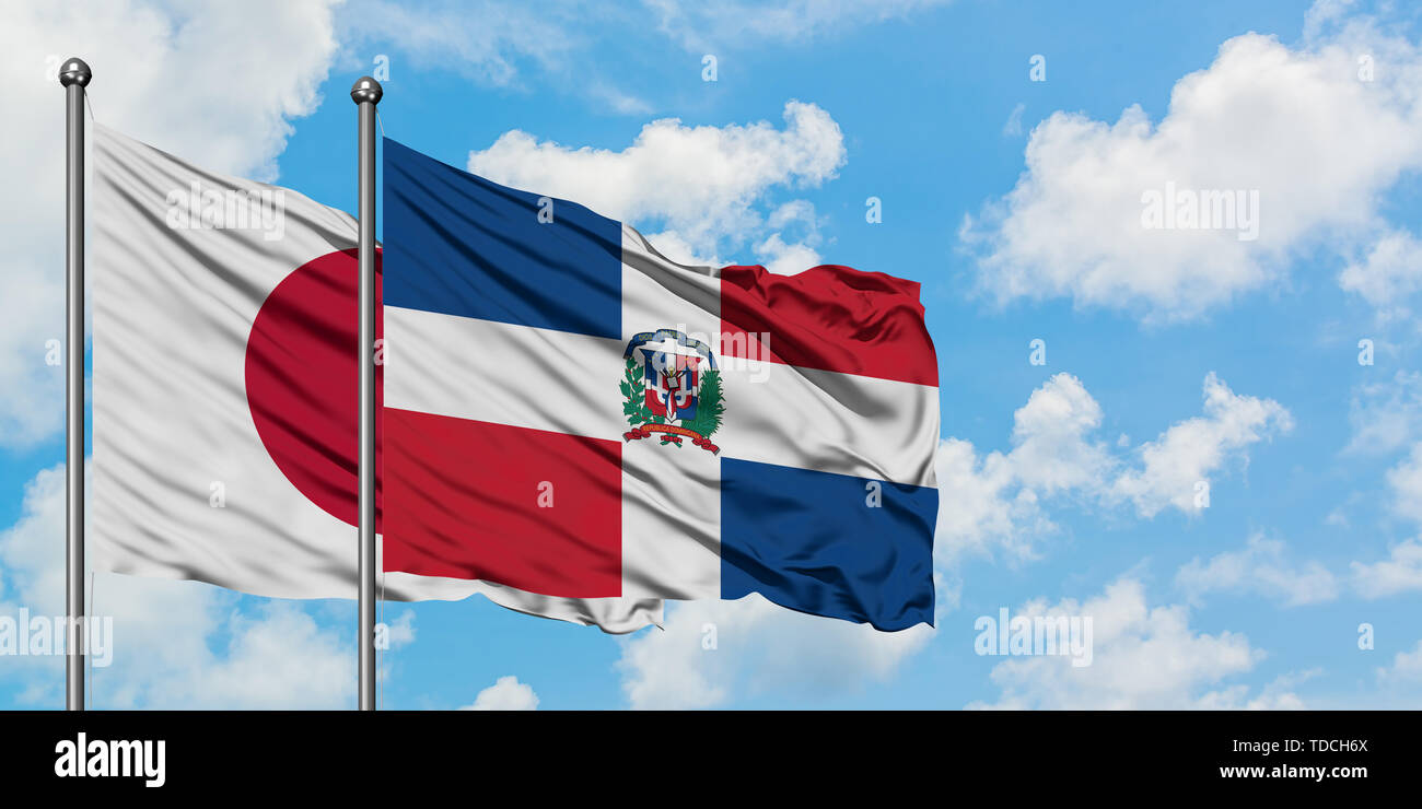 Japan and Dominican Republic flag waving in the wind against white ...