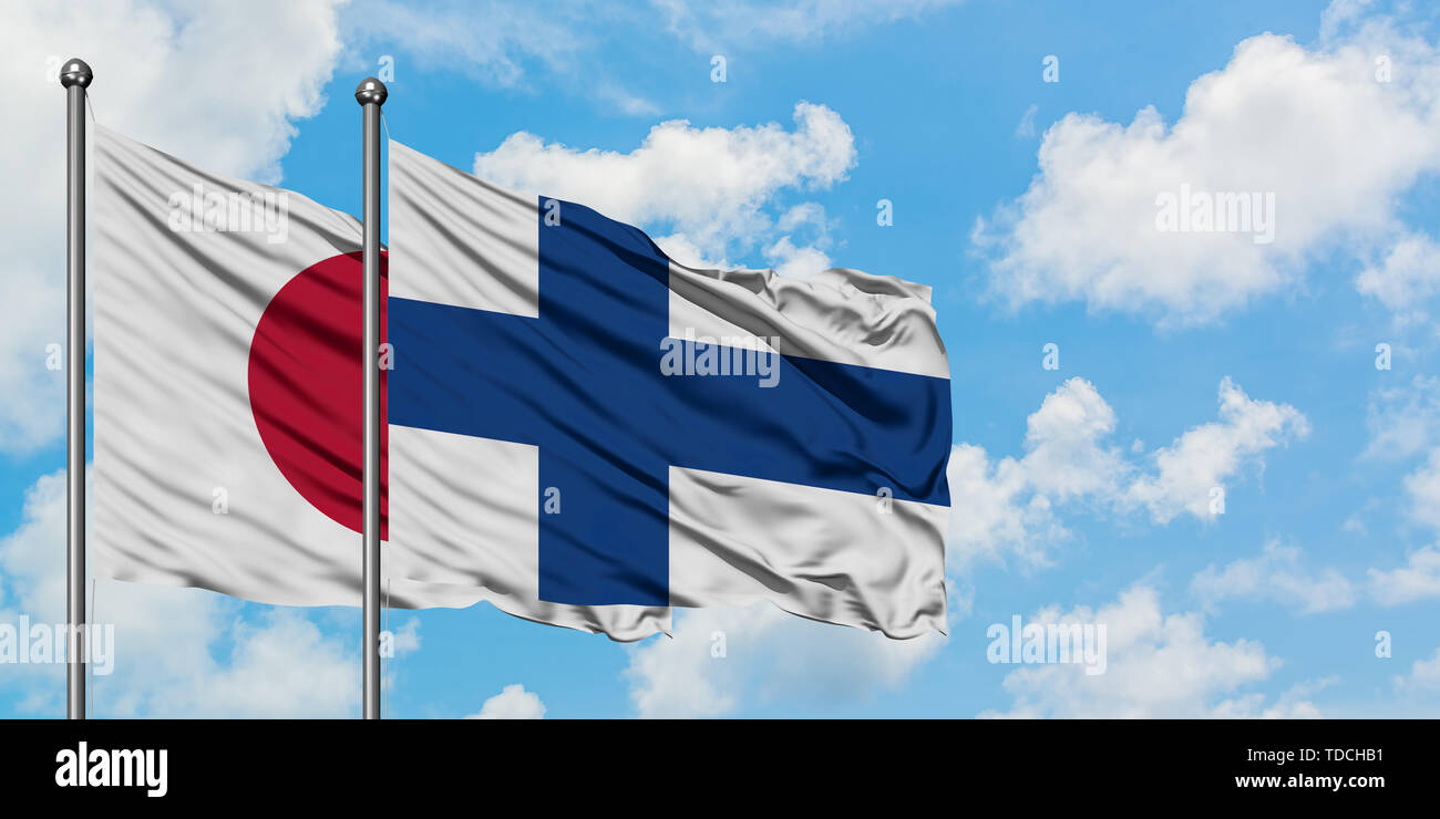 Japan and Finland flag waving in the wind against white cloudy blue sky ...