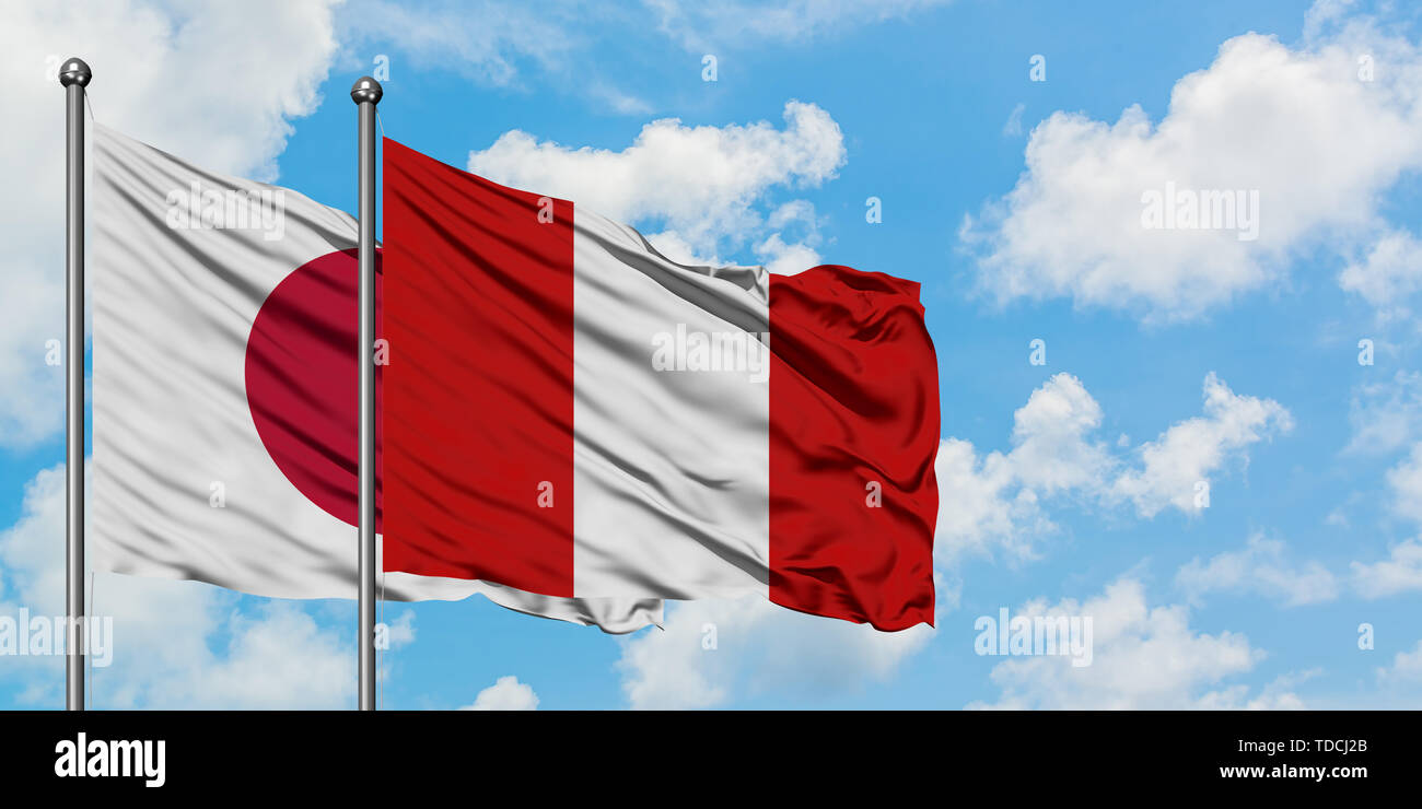 Japan and Peru flag waving in the wind against white cloudy blue sky ...