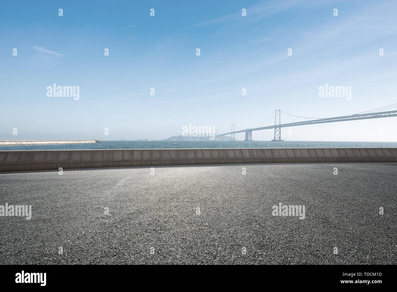 empty road with suspension bridge in blue sky Stock Photo - Alamy
