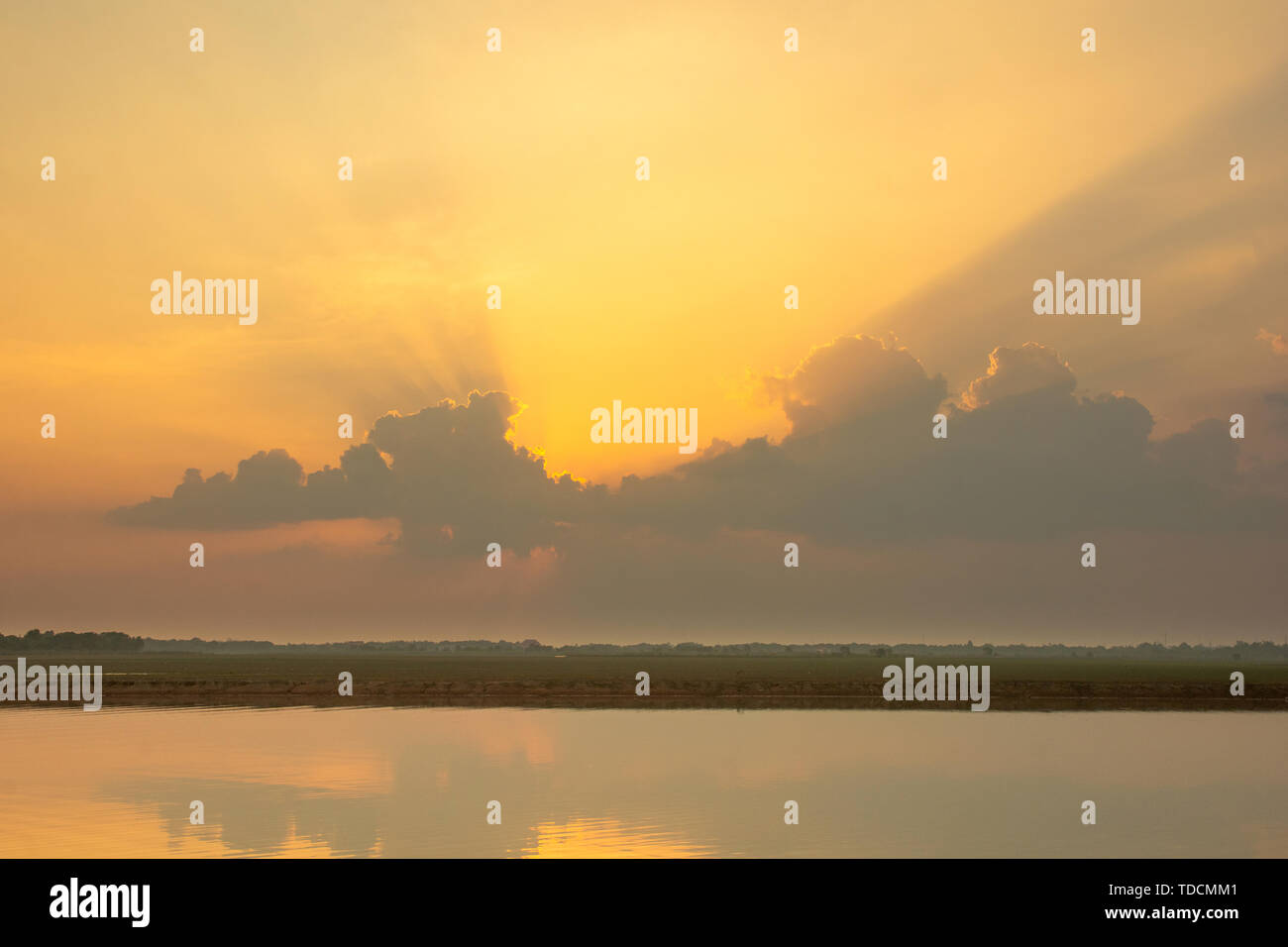 Sunset sunlight through clouds background Stock Photo - Alamy