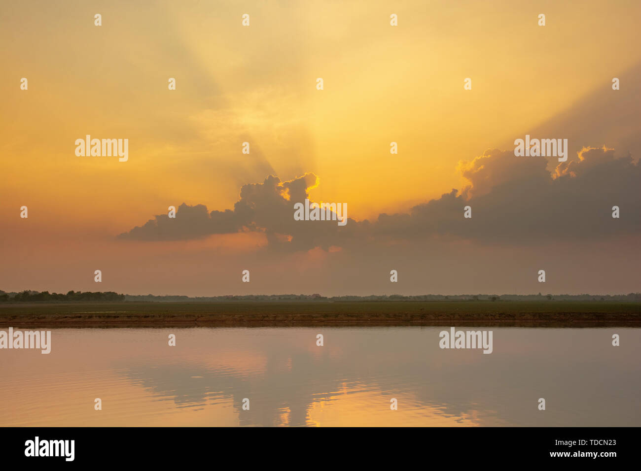 Sunset sunlight through clouds background Stock Photo - Alamy