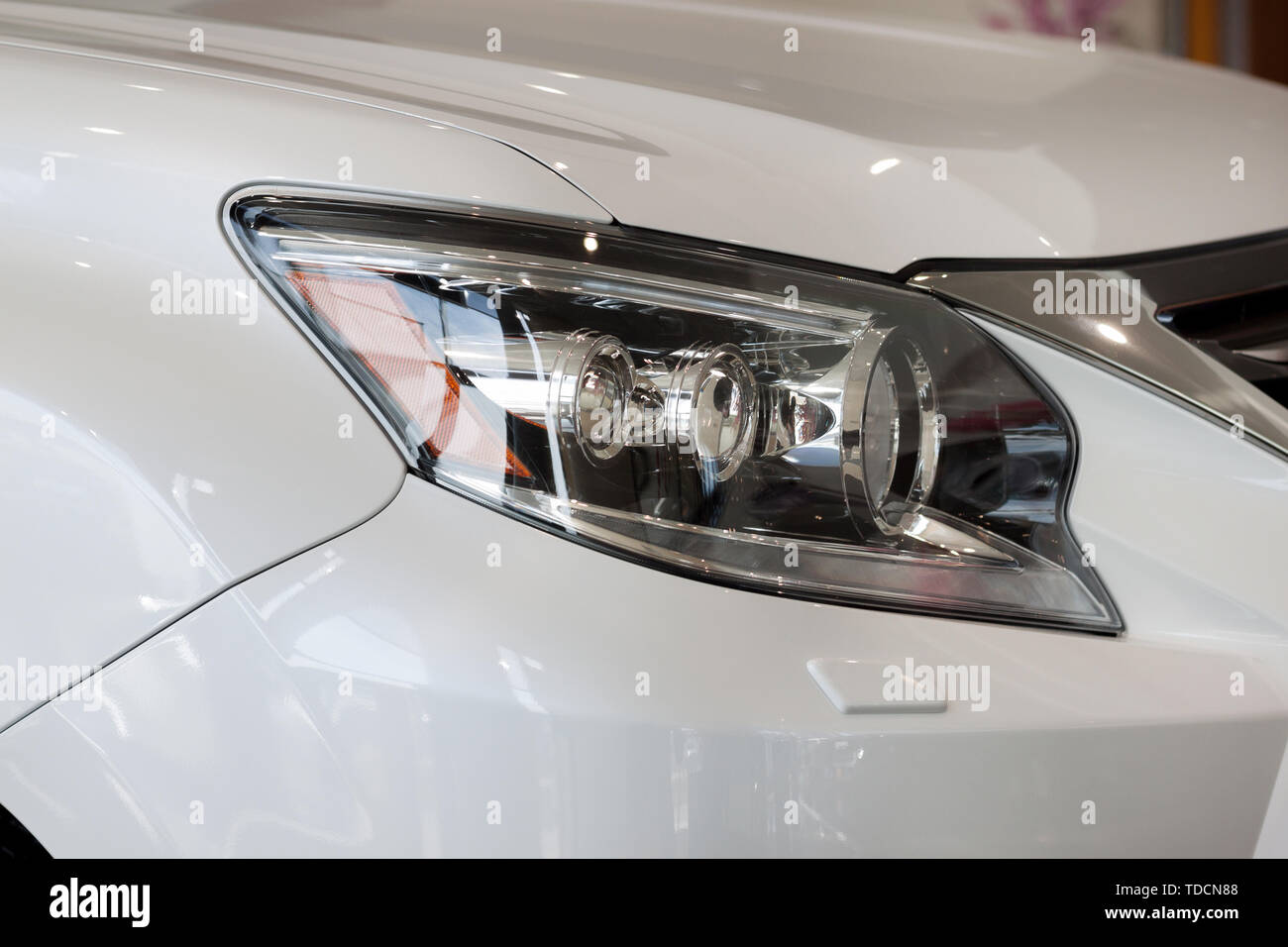 New white car with elegant head lamps. Side view. Modern transportation ...