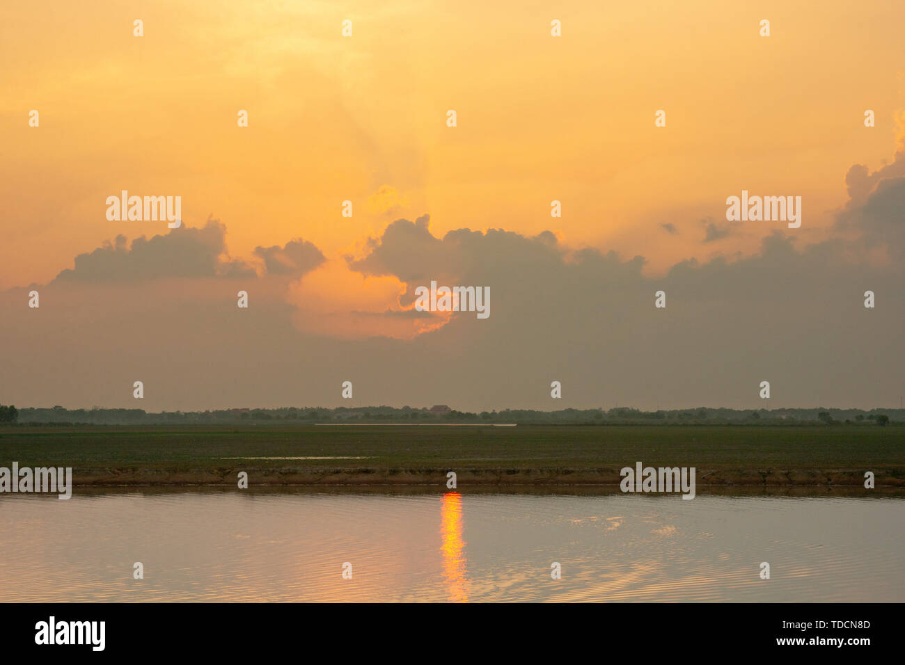 Sunset sunlight through clouds background Stock Photo - Alamy
