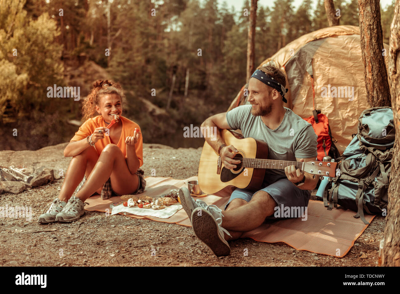 Happy positive man holding a musical instrument Stock Photo - Alamy