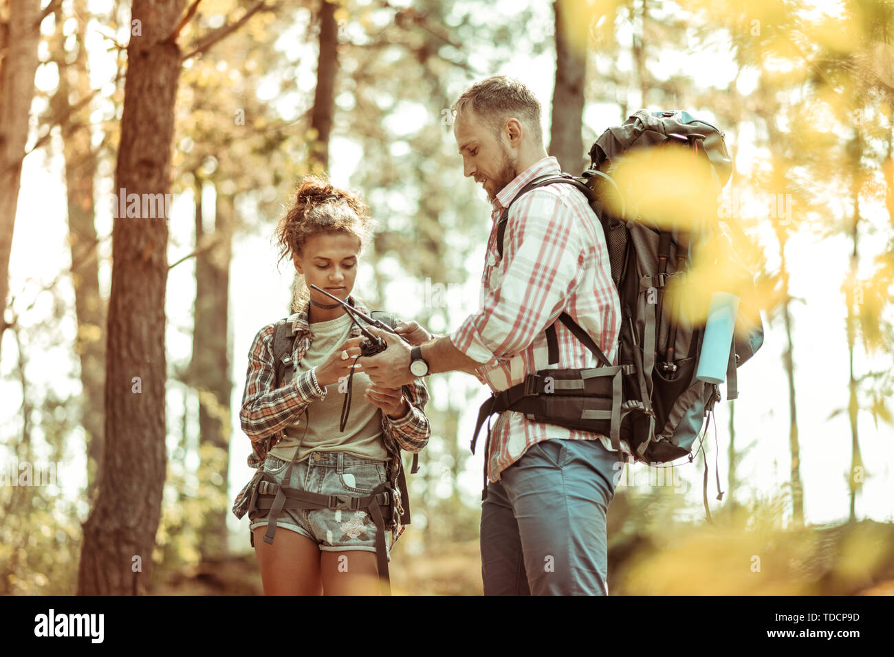 Pleasant young people using their walkie talkies Stock Photo - Alamy