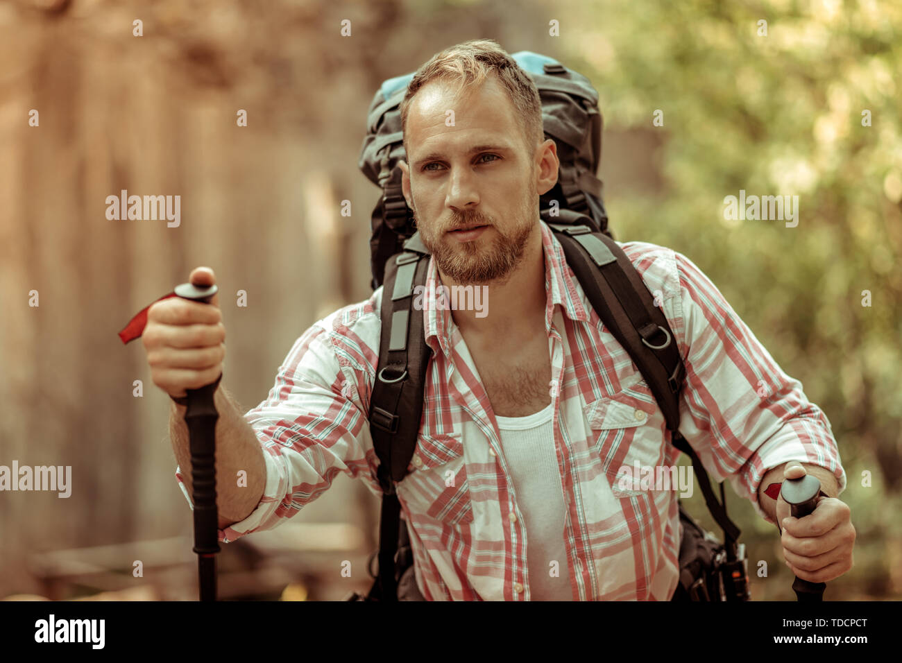Nice handsome man holding a walking stick Stock Photo - Alamy
