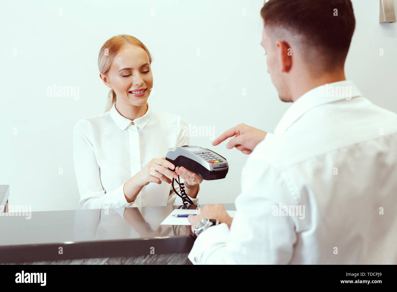 Businessman Arriving At Reception Desk High Resolution Stock ...