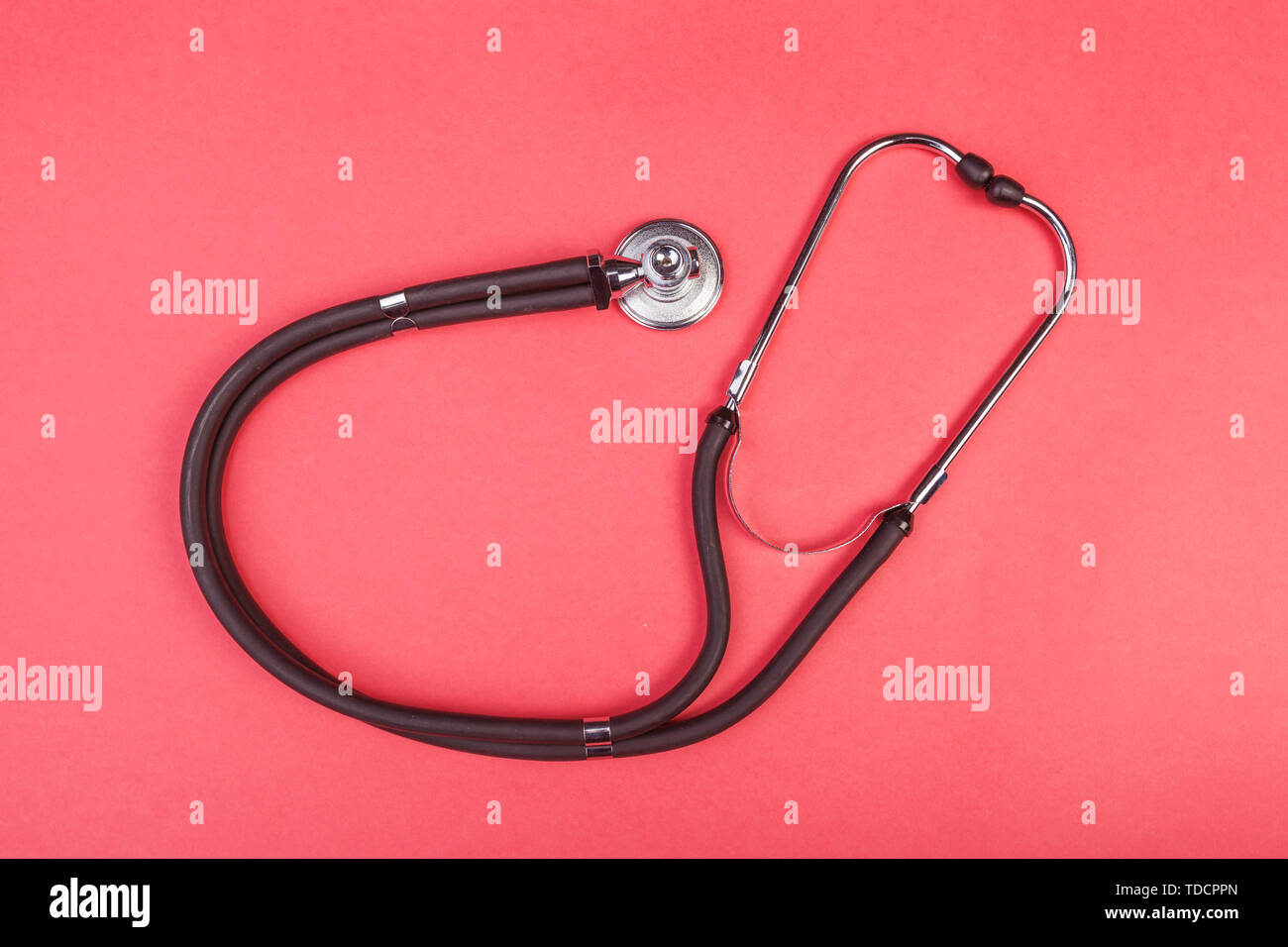 Stethoscope isolated on red background Stock Photo - Alamy