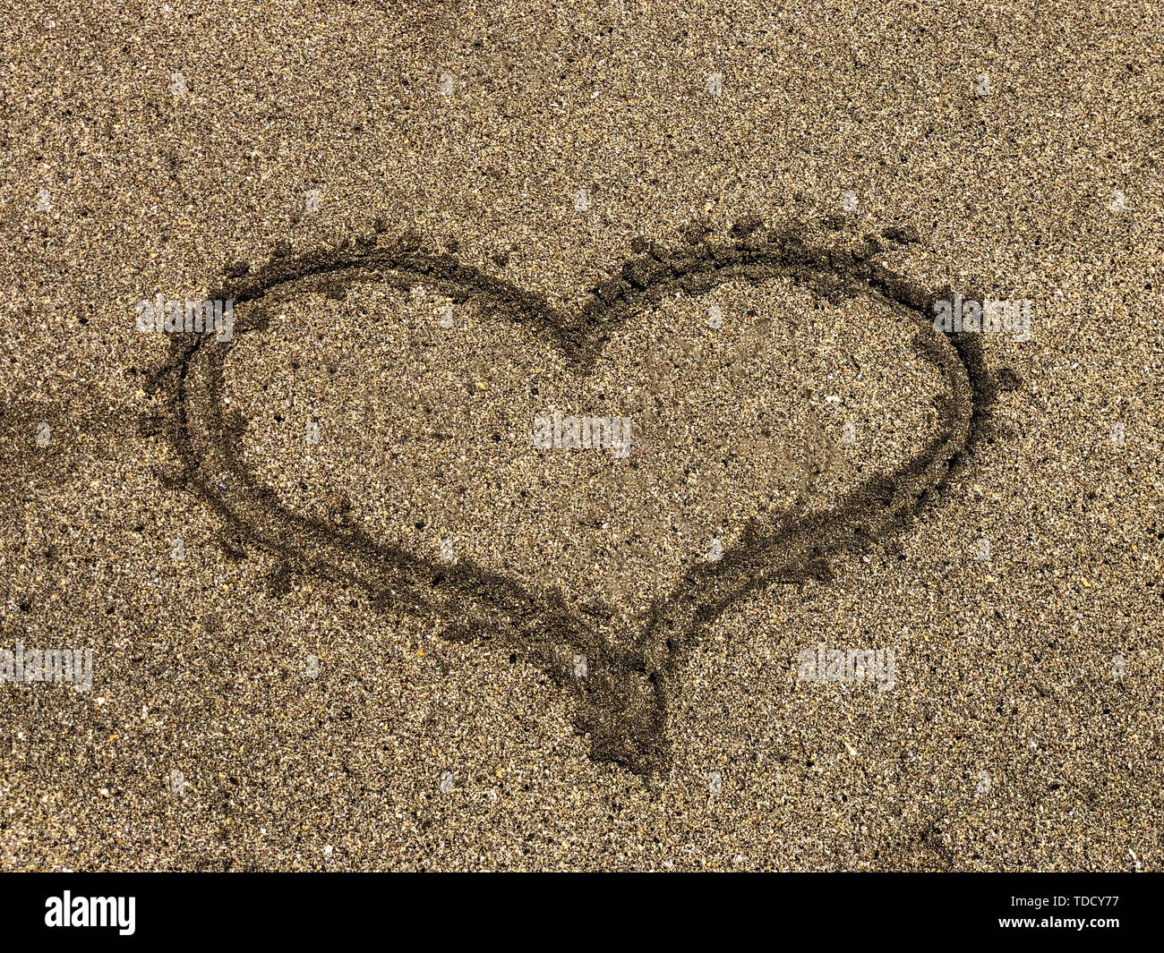 Drawing in sand with finger hi-res stock photography and images - Alamy