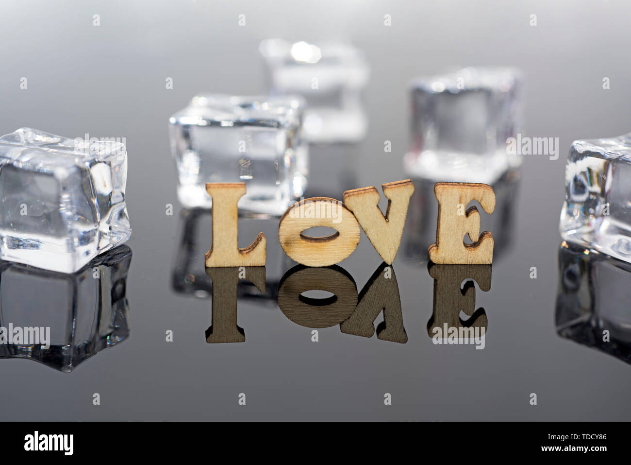 Abstract composition of love. Isolated wooden letters and glass balls ...