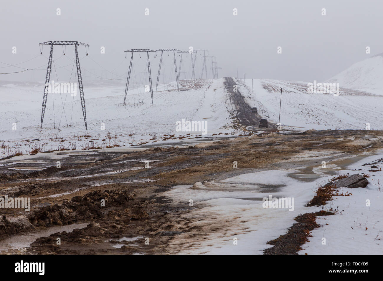 High voltage poles on a snow-covered hill, Mutnowskaya Power Station ...