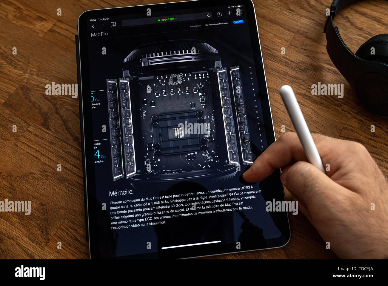 Paris, France - Jun 6, 2019: Man reading on Apple iPad Pro tablet about ...