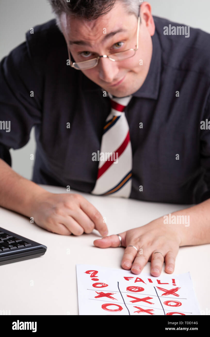 Failure and loss concept with a businessman holding a sheet showing a ...