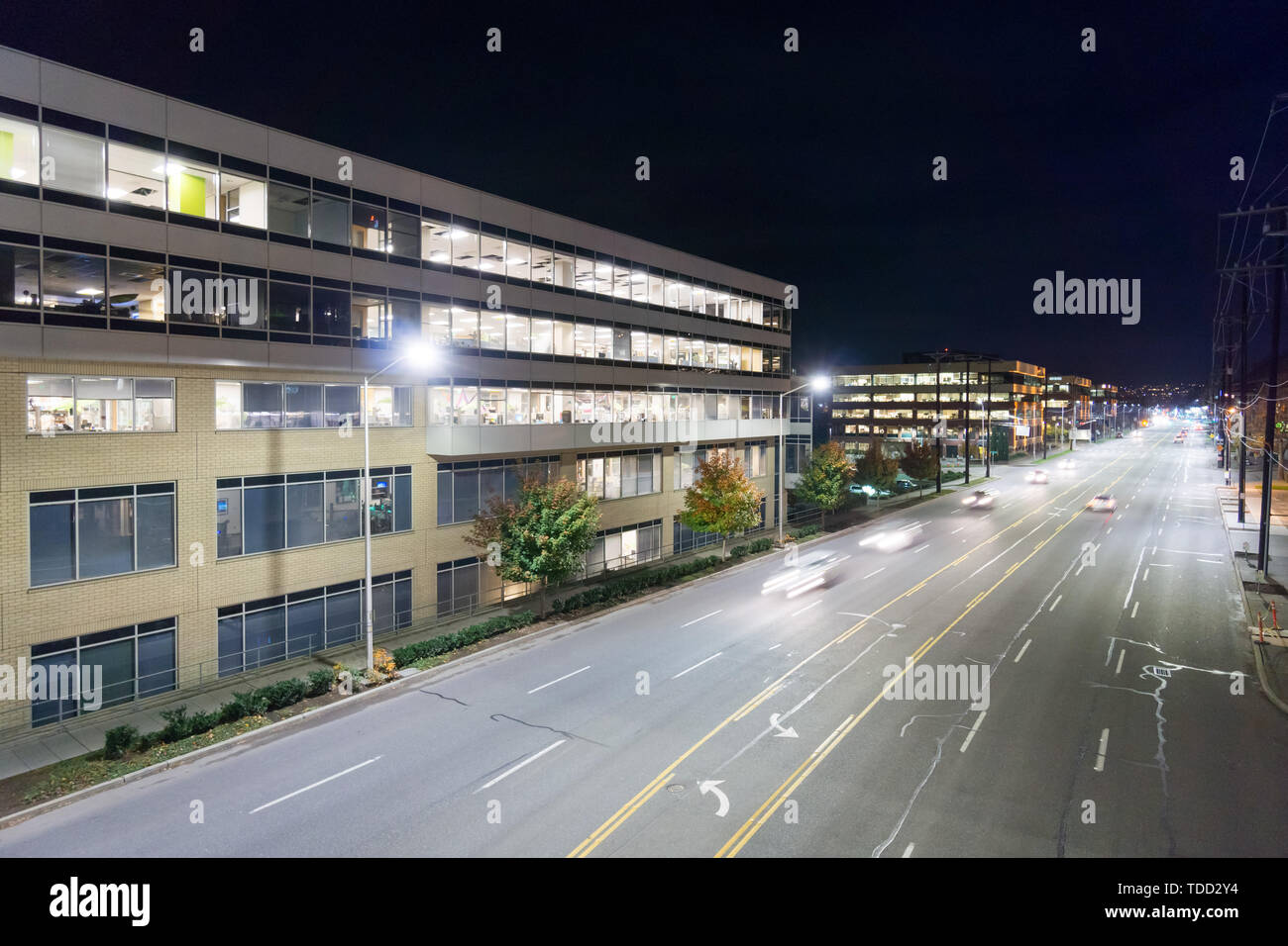Traffic on road front of building Stock Photo - Alamy