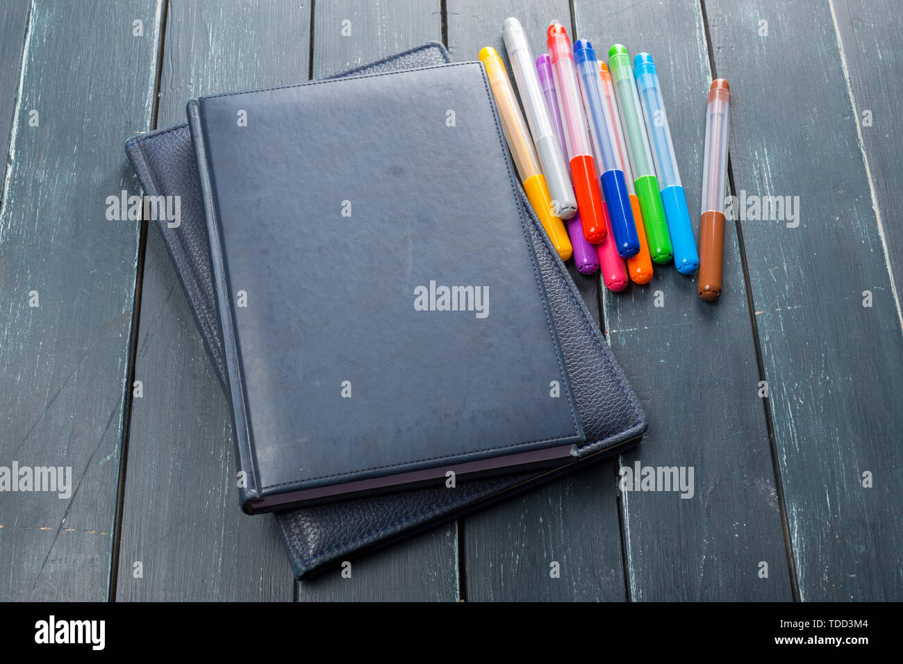 Office table with notebook and markers Stock Photo - Alamy