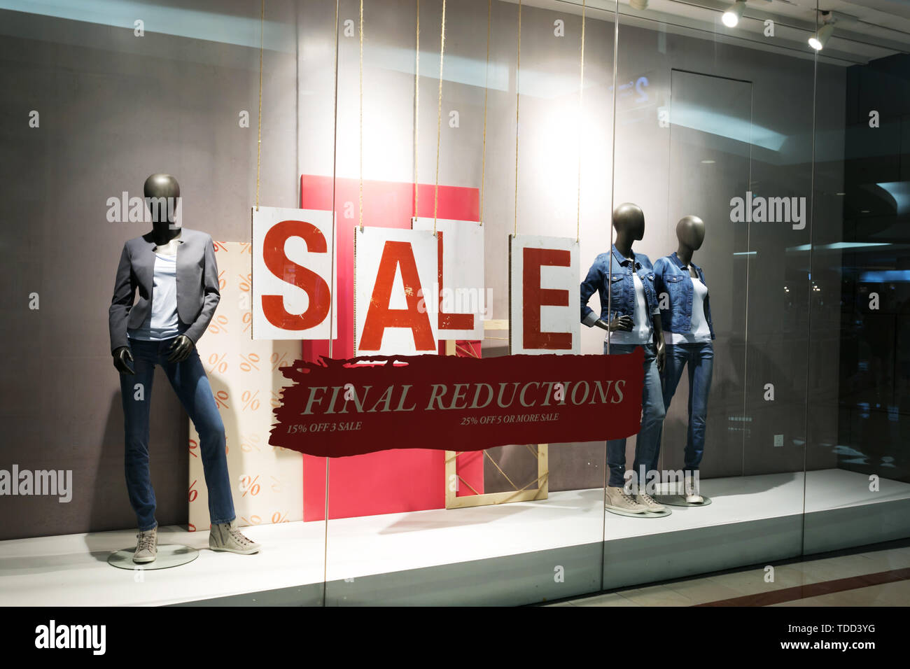 clothes storefront window with sale poster Stock Photo - Alamy