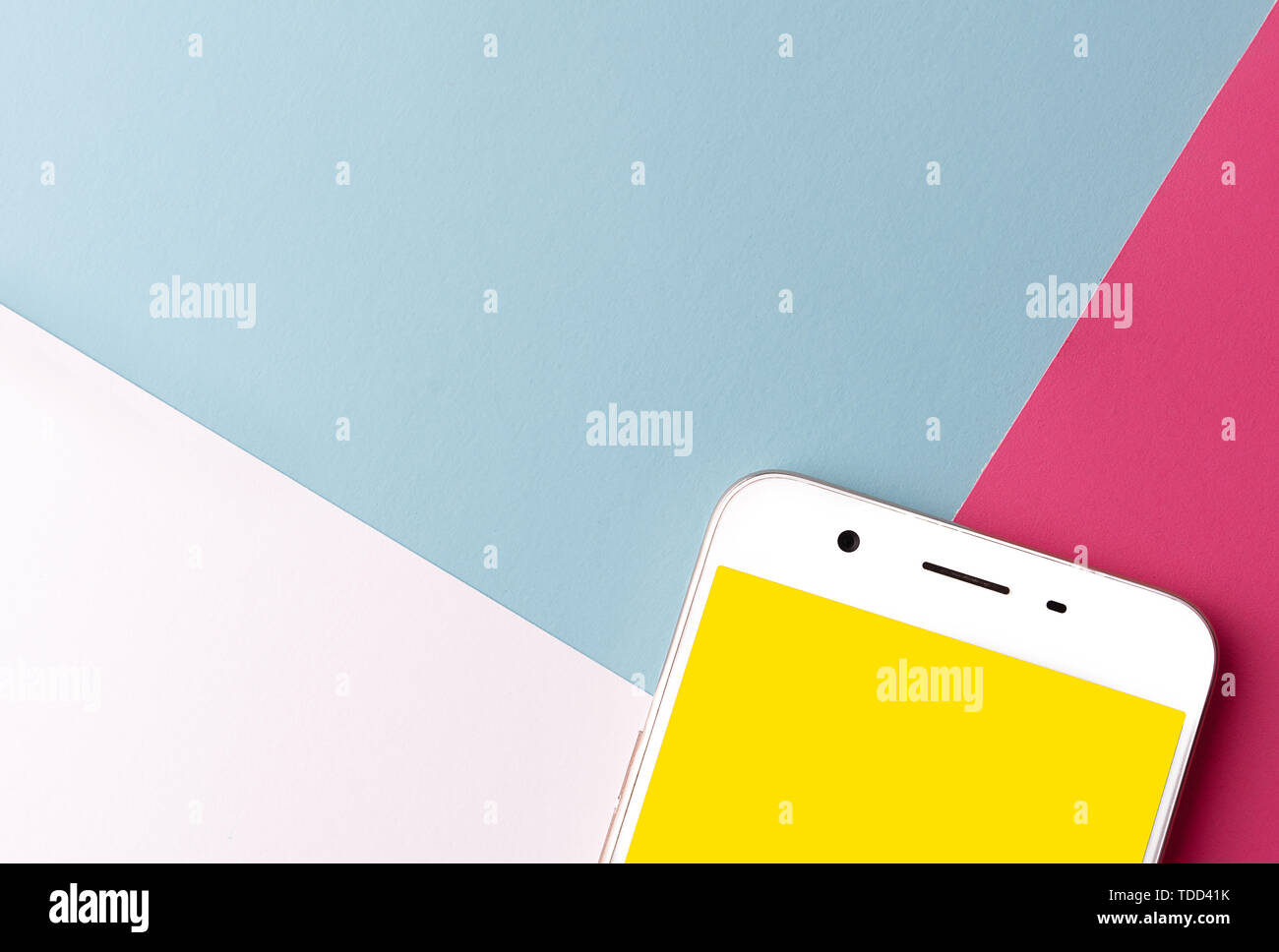Smartphone on solid color background Stock Photo - Alamy
