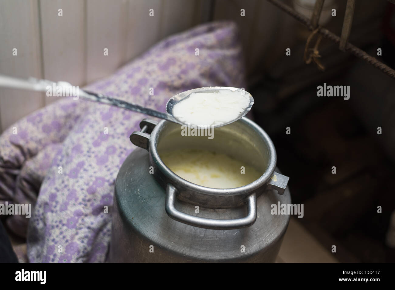 Cooking cottage cheese and cheese at home. Man creates cheese, heating ...