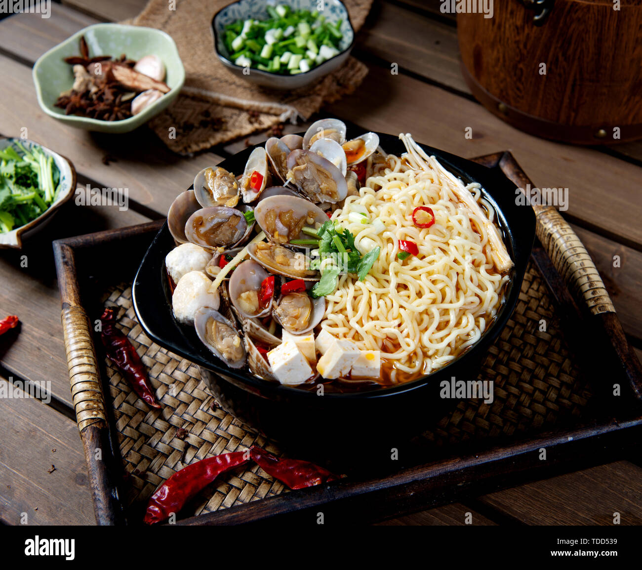 Golden soup, spicy flower armor, pink noodles Stock Photo - Alamy