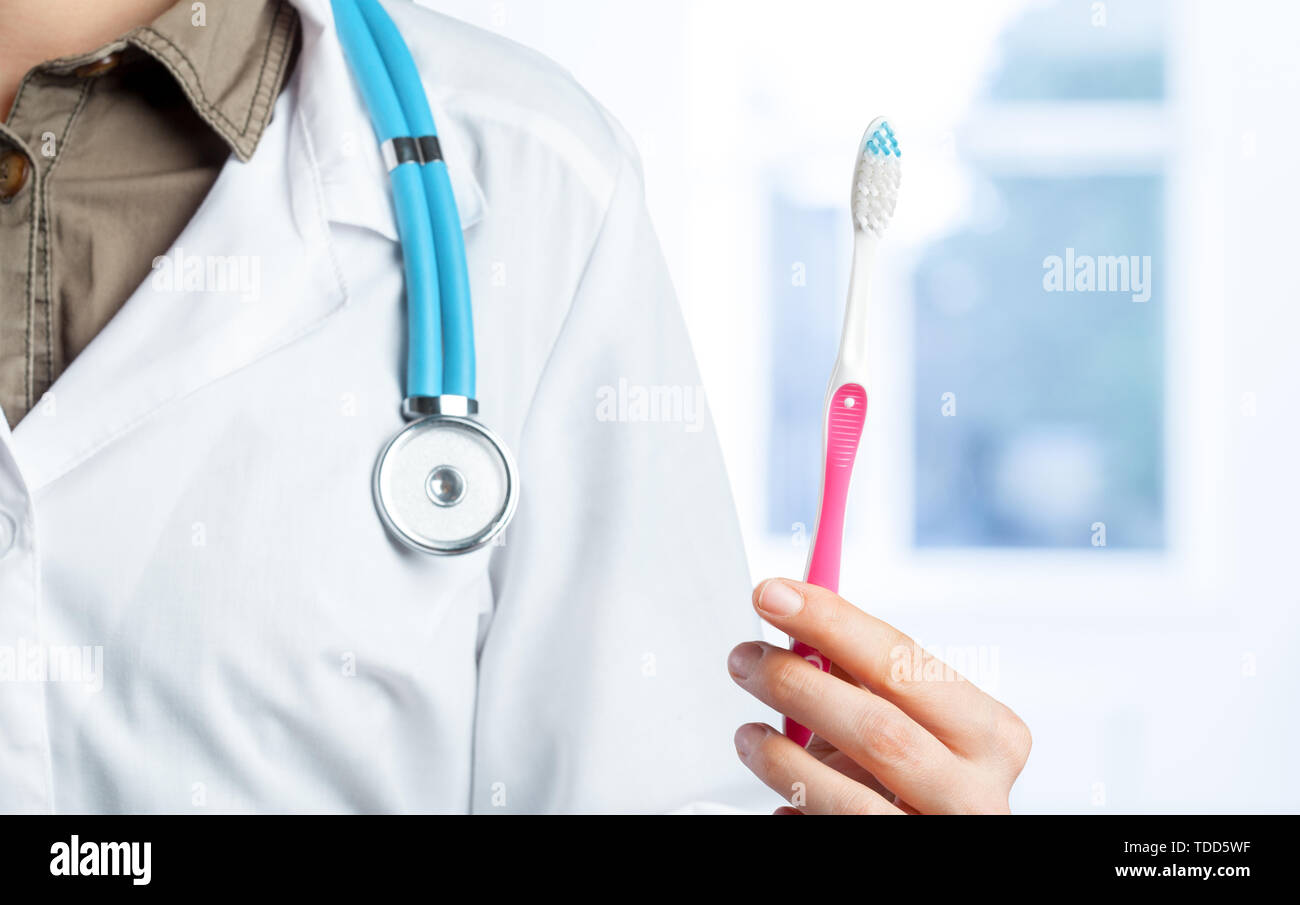 dentist hand with toothbrush Stock Photo - Alamy