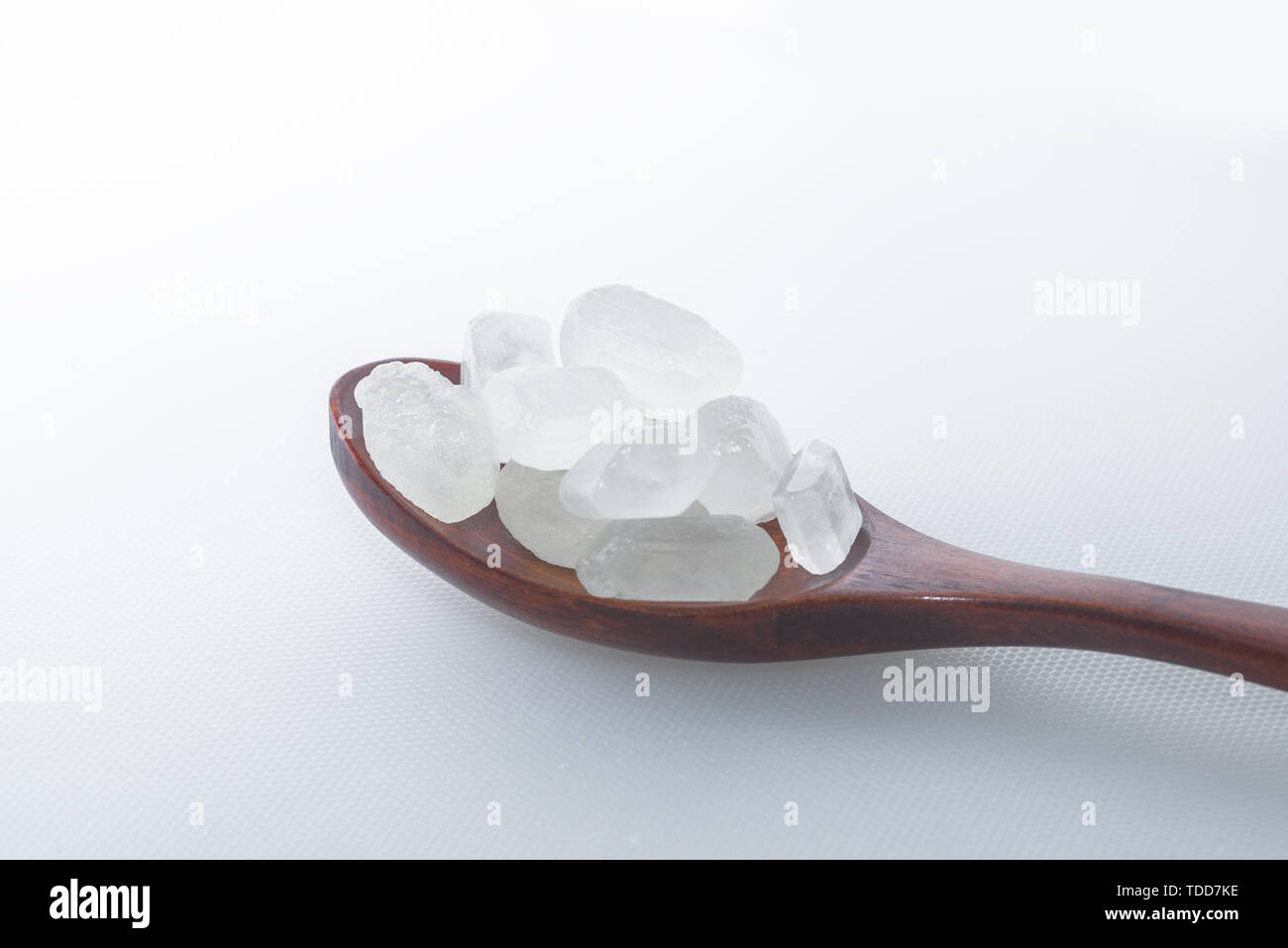 A spoonful of ice sugar placed on a white background Stock Photo - Alamy