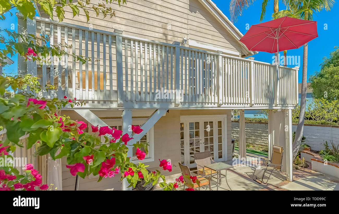 Panorama frame Patio with an eating area under the balcony with a red ...