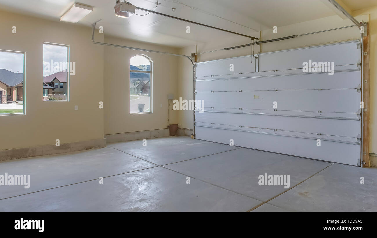 Panorama frame Empty garage with white doors as well as arched and ...
