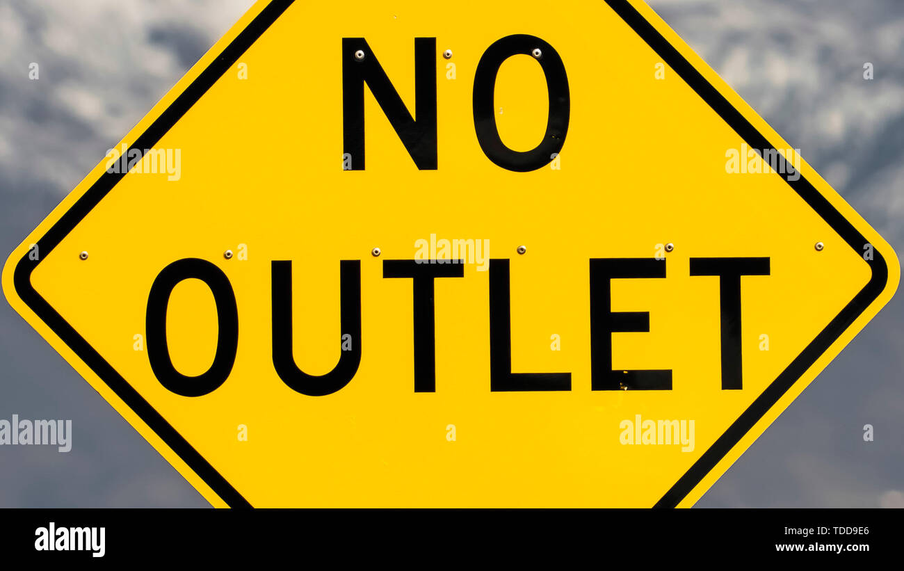 Panorama Close up view of a bright yellow and black No Outlet road sign ...