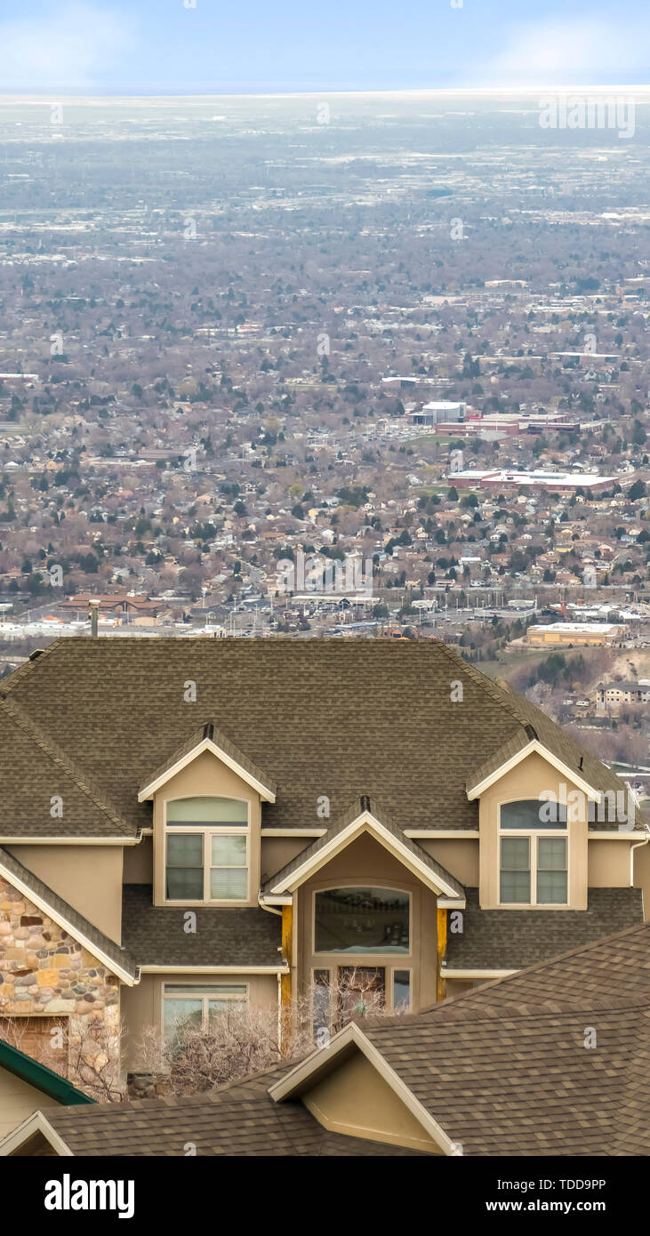 Vertical frame Aerial view of homes on a vast valley with the horizon ...