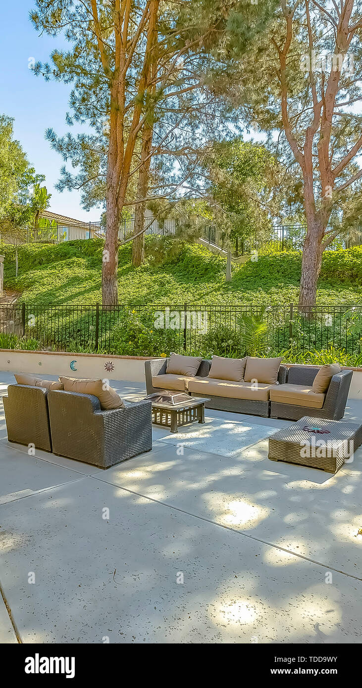 Vertical frame Seating area on the patio of a house surrounded by lush ...