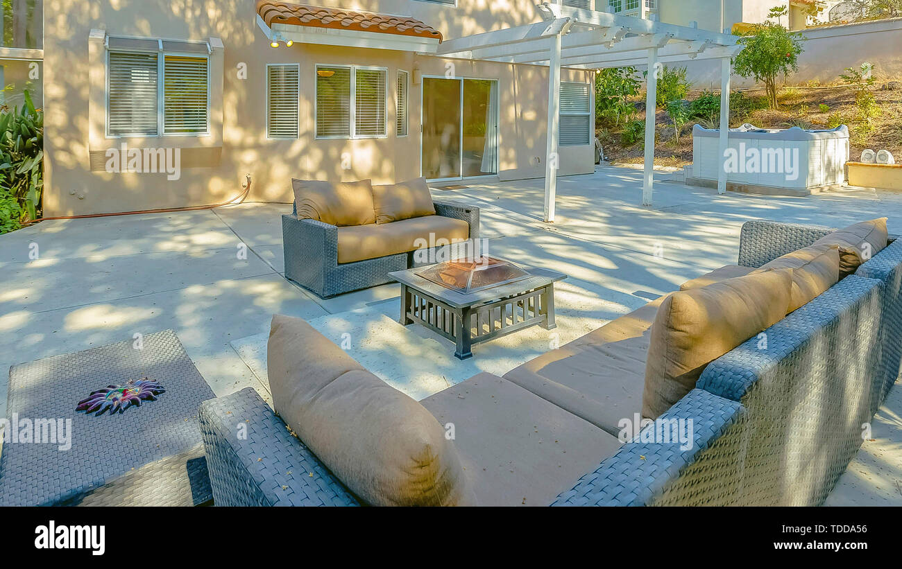 Panorama Outdoor seating area on the patio of a house lit by sunlight ...