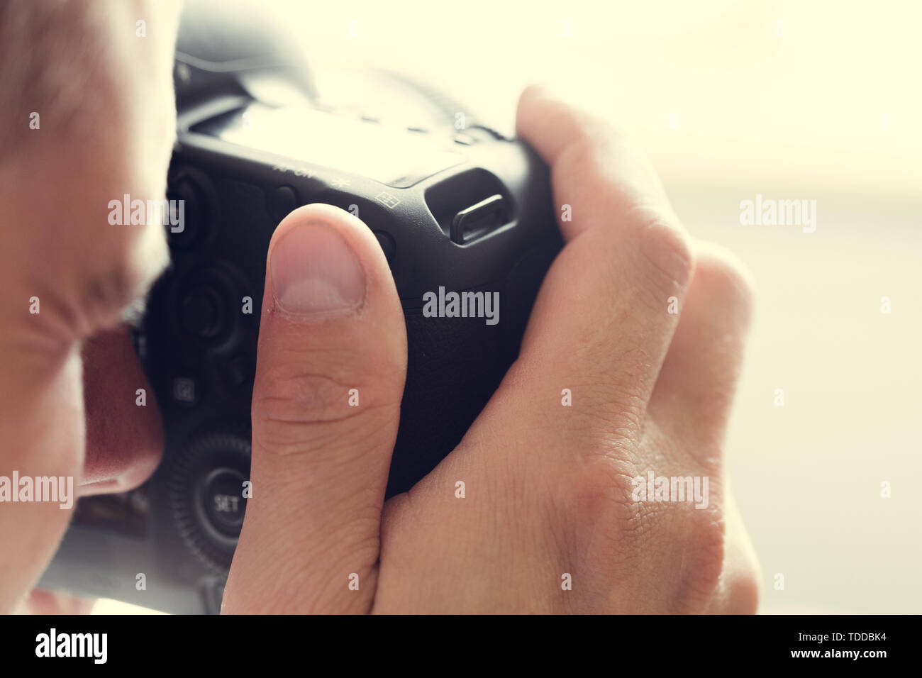 photographer with camera in hand Stock Photo - Alamy