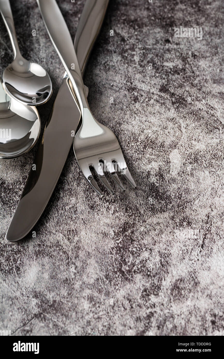 Shiny metal forks, knives and spoons Stock Photo - Alamy