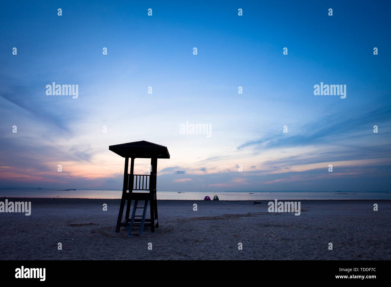 Observation tower on the beach with sunrise Stock Photo - Alamy