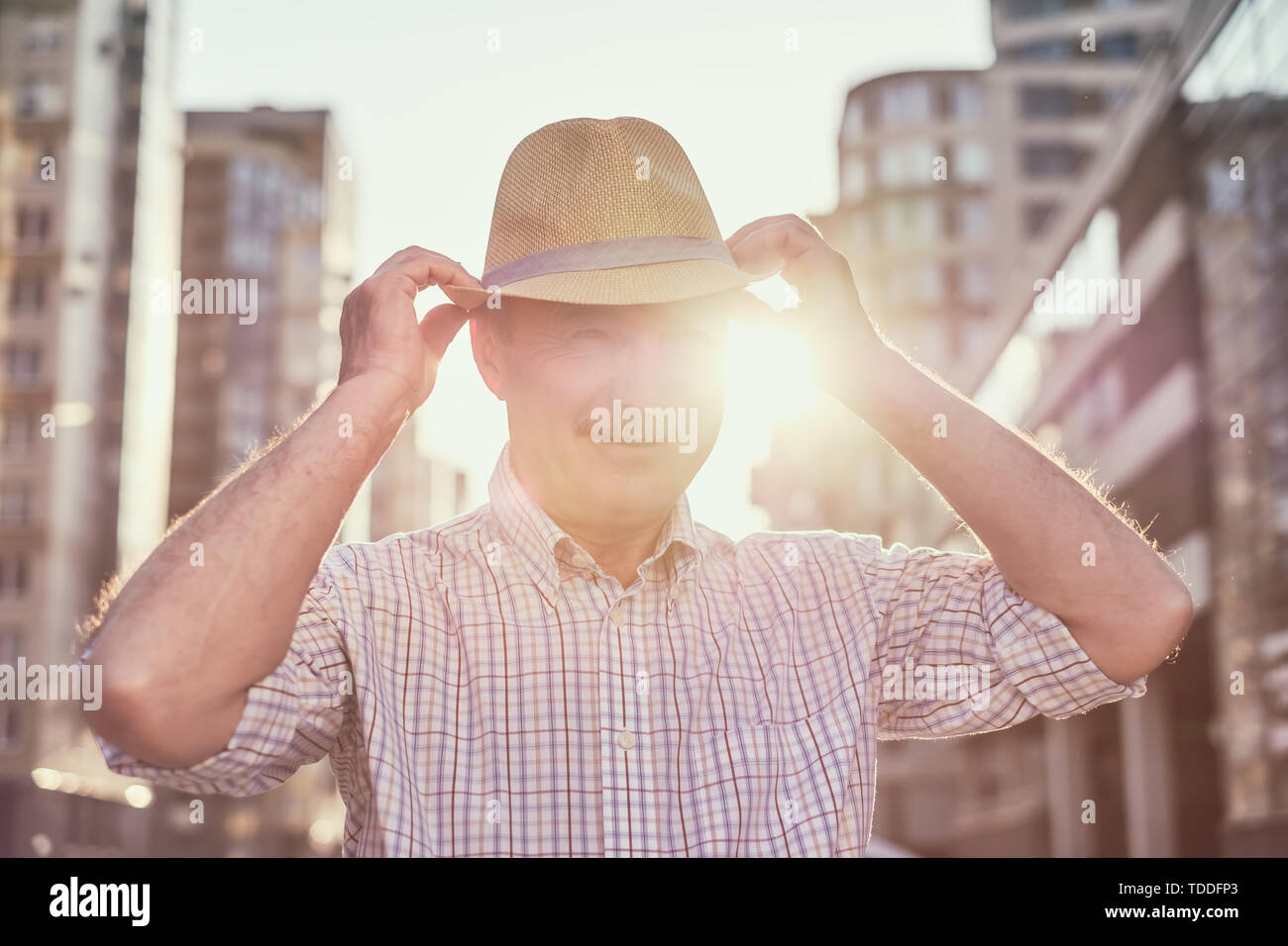 Retired senior hispanic man with hat standing and smiling Stock Photo ...