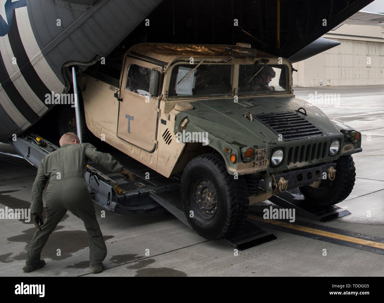U.S. Army troops load a Humvee into a C-130 Hercules during RED FLAG ...