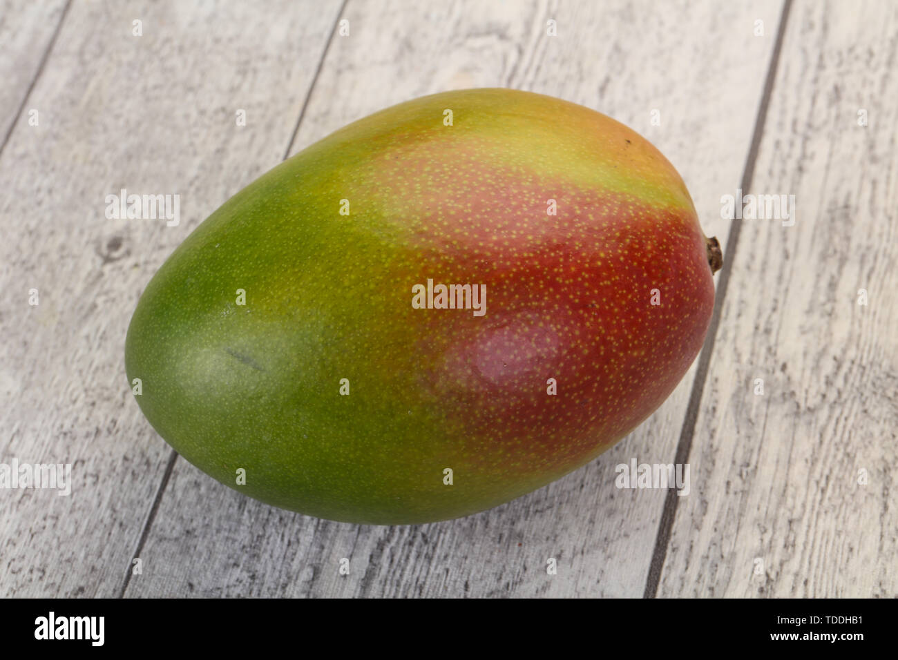 Sweet tasty mango over wooden background Stock Photo - Alamy