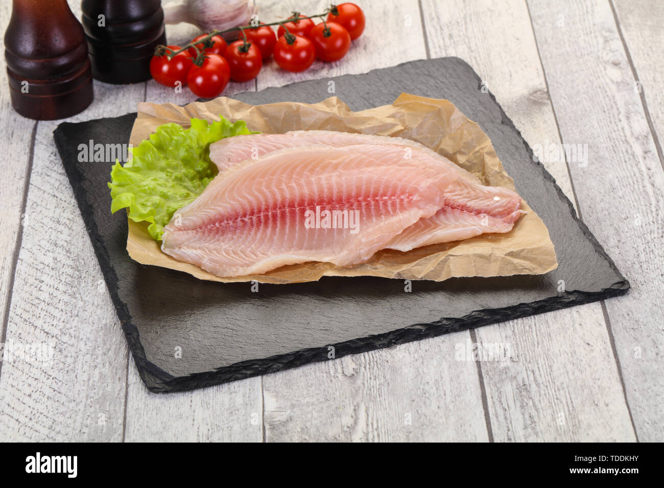 Raw tilapia fish ready for cooking Stock Photo - Alamy