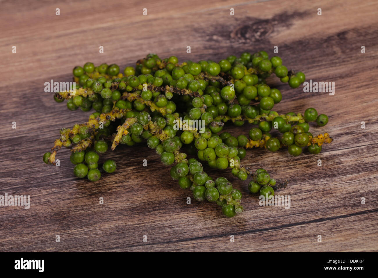 Raw fresh green pepper corn over wooden background Stock Photo - Alamy