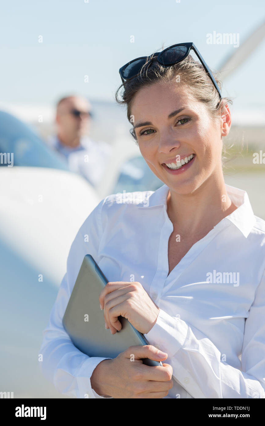 female pilot smiling near a small plane before the flight Stock Photo ...