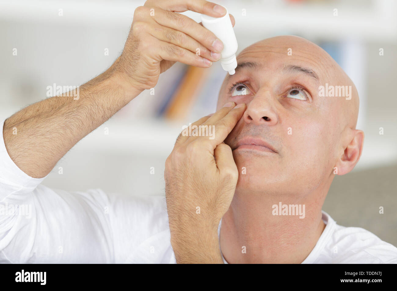 man dripping eye drops with hand Stock Photo - Alamy