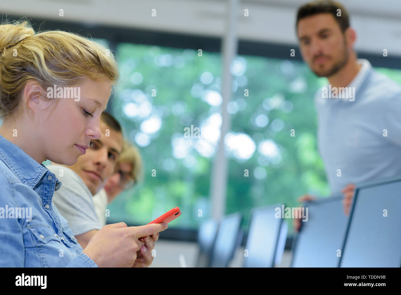 student using smartphone in classroom Stock Photo - Alamy