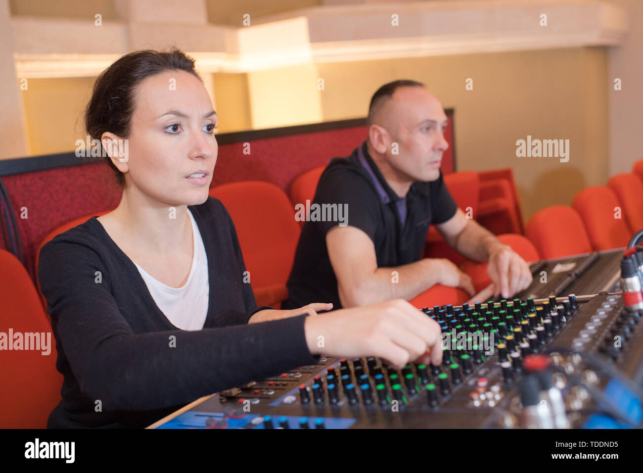 sound engineer working at mixing panel in boutique recording studio ...
