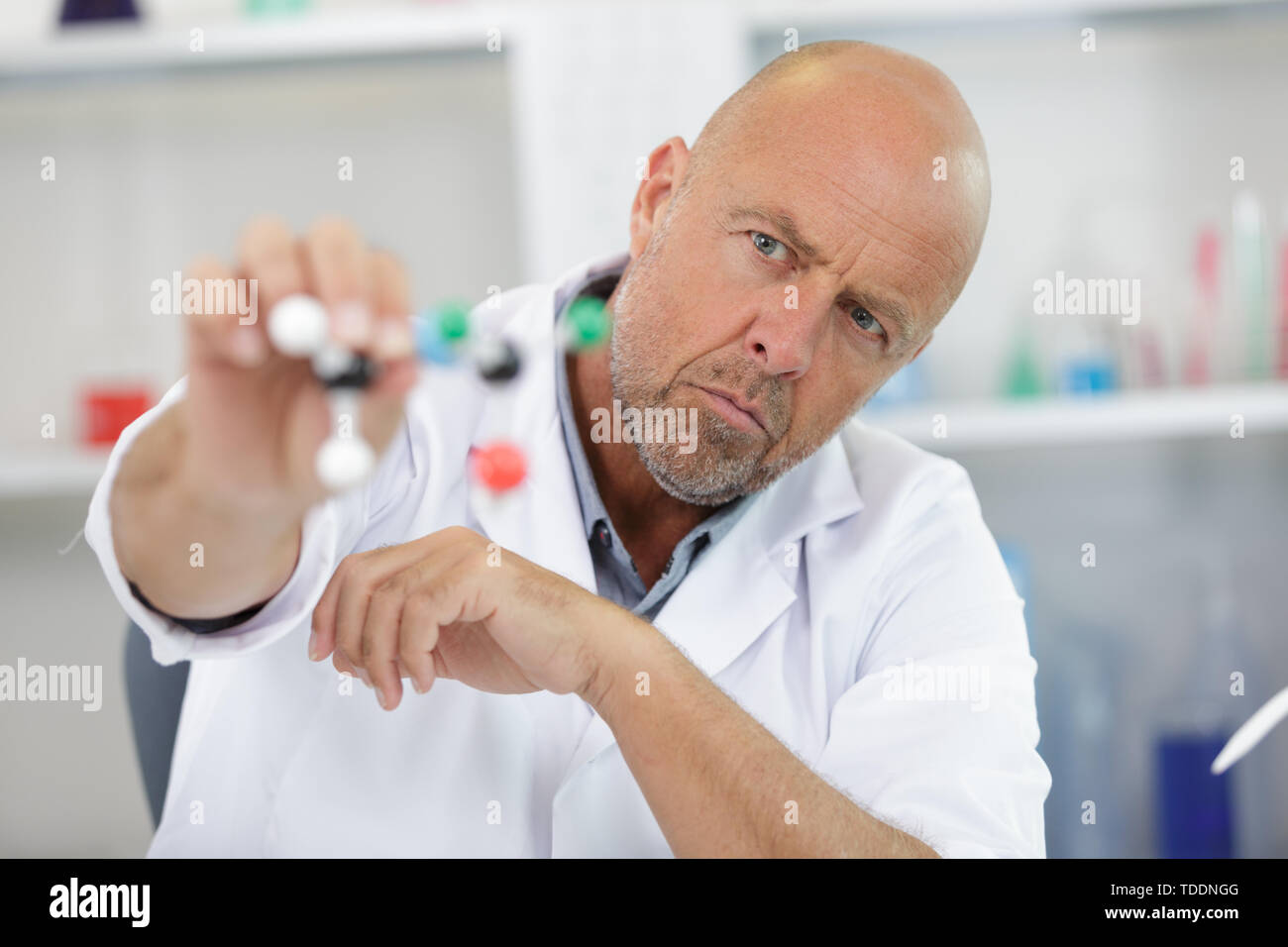 medical scientist looking dna model Stock Photo - Alamy