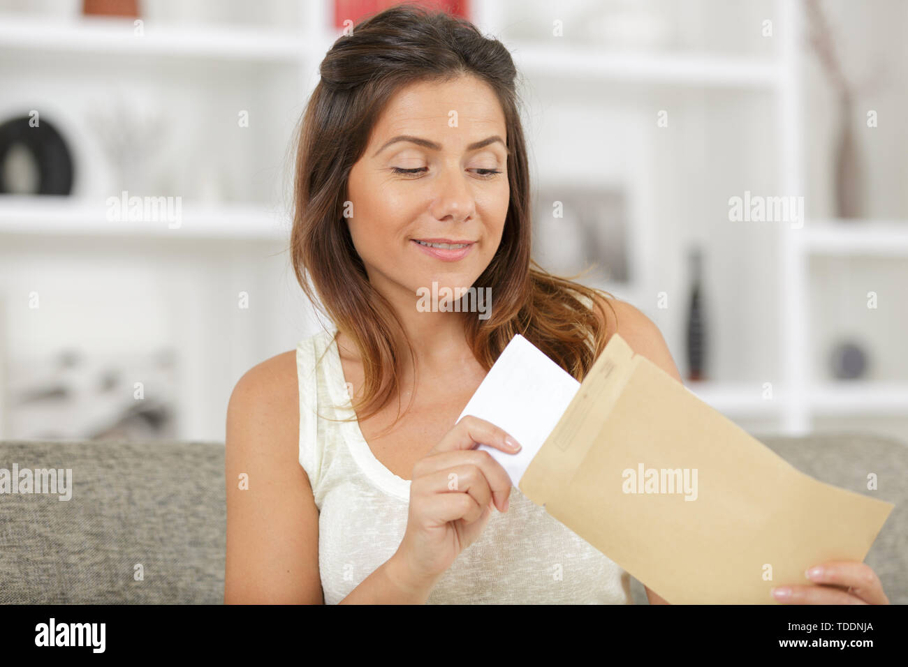 woman putting letter inside envelop Stock Photo - Alamy